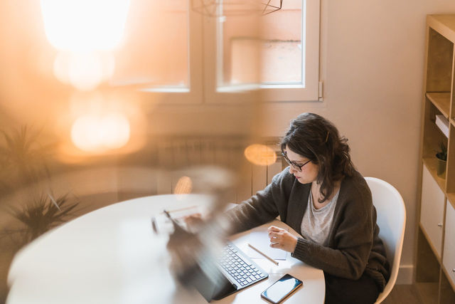 Woman using mobile phone at home | ID: 160289097