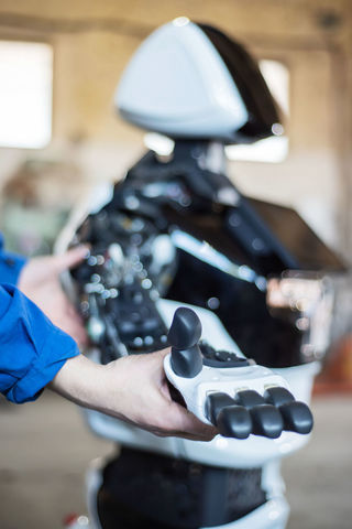 Man working on robot | ID: 175651316