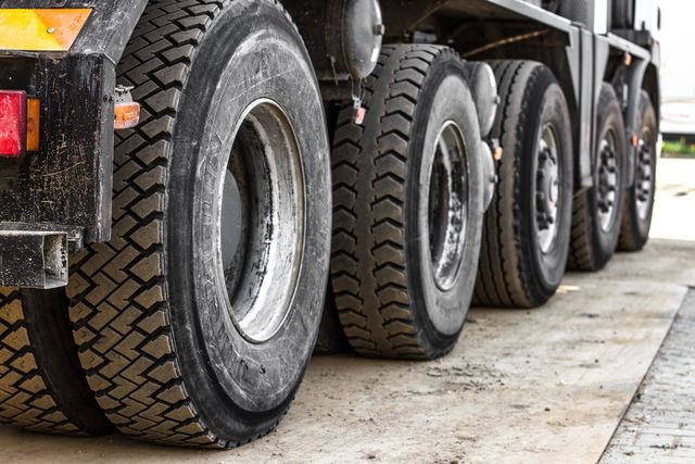 Row of rubber semi-truck tires | ID: 75866646