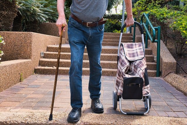 Elderly disabled person with a stick walks | ID: 213863739