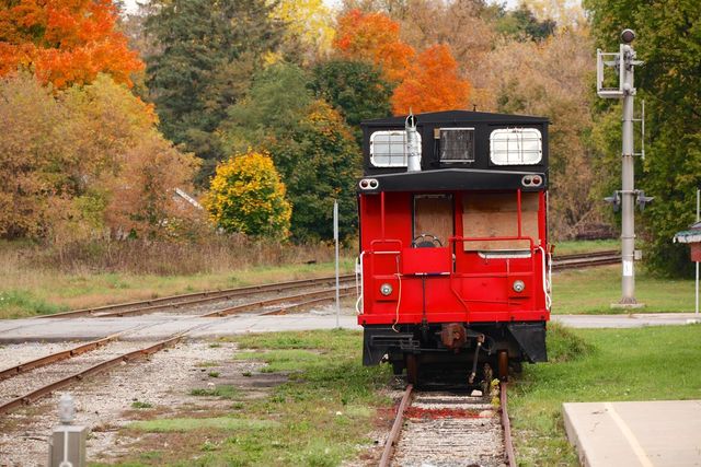 Red railroad car on tracks during autumn | ID: 130720799