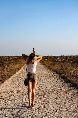 Rear view of woman walking on landscape | ID: 123306088