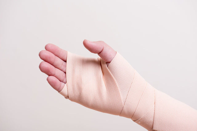 Cropped hand wrapped with bandage against | ID: 123038584